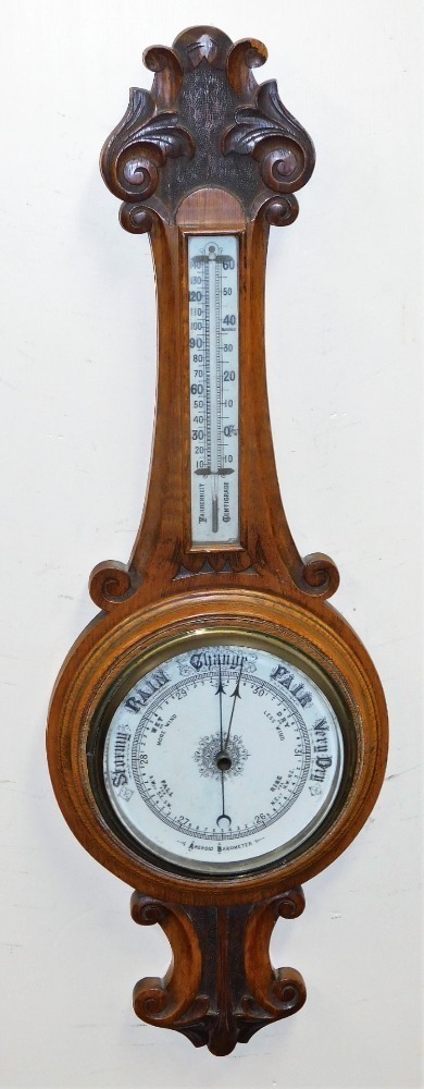 A Victorian oak cased aneroid barometer, with mercury Fahrenheit and ...