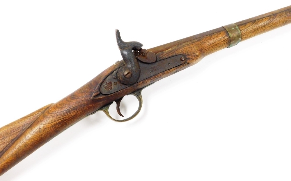 A Victorian Tower flint lock rifle, with an elm stock, the steel barrel ...