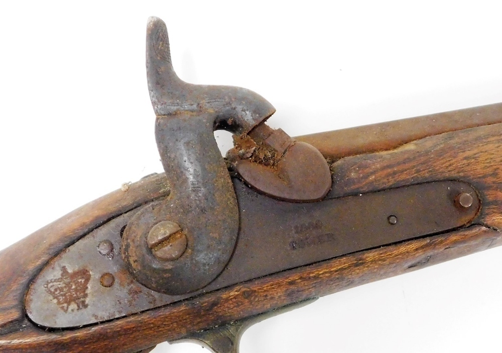A Victorian Tower flint lock rifle, with an elm stock, the steel barrel ...