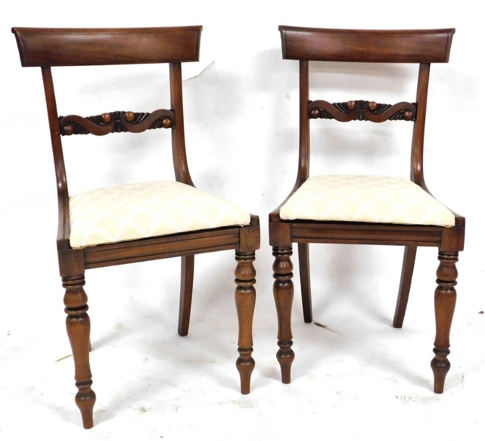 A pair of late Regency mahogany dining chairs, with overstuffed ...