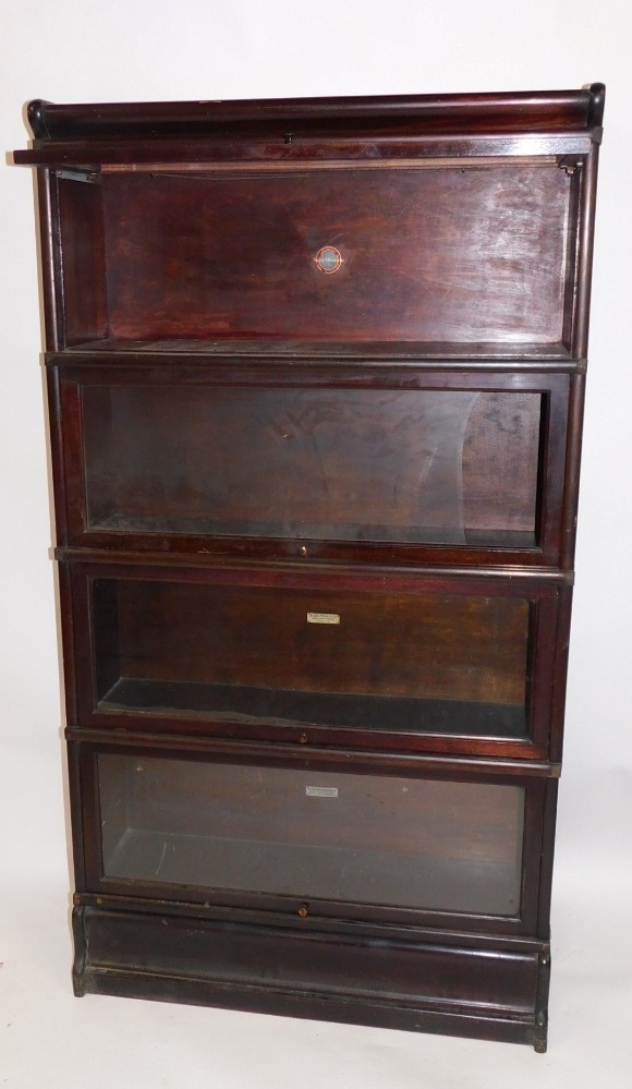 A Globe Wernicke mahogany four section bookcase, the pediment over four ...
