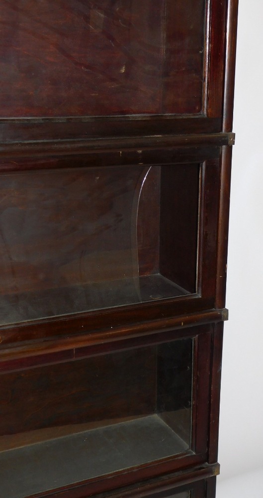 A Globe Wernicke mahogany four section bookcase, the pediment over four ...