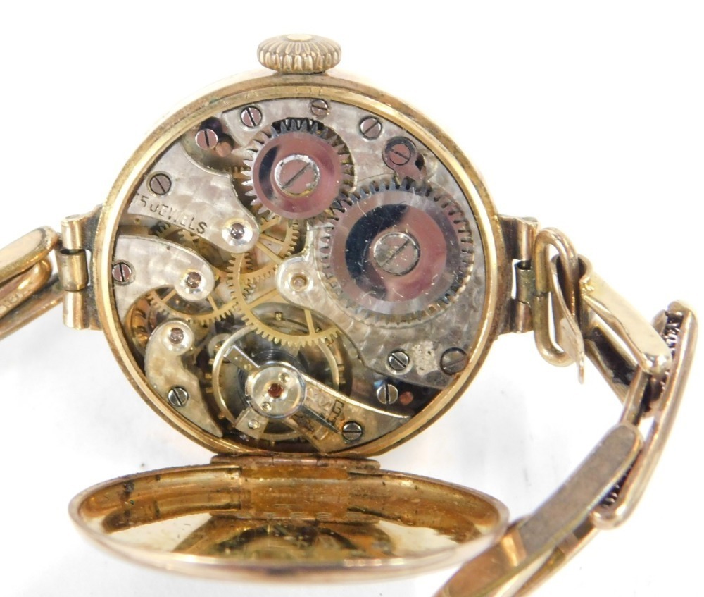 A 9ct gold cased wristwatch, the circular wristwatch head with a ...