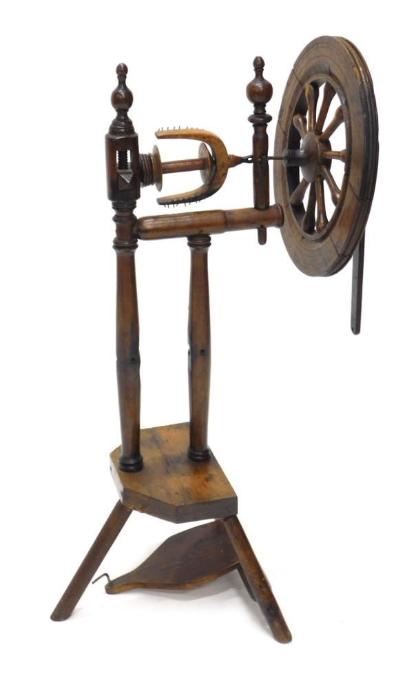 A principally 19thC oak spinning wheel, with articulated wheel, turned ...