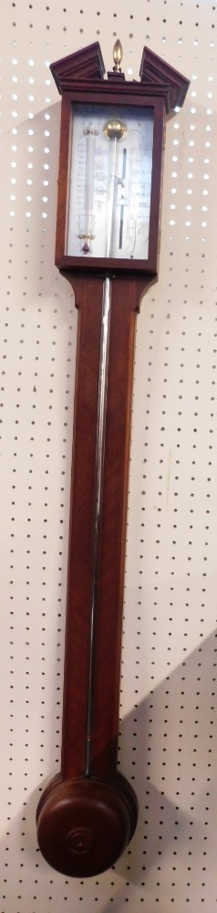 A modern mahogany cased stick barometer, with a silvered dial, 94cm high.