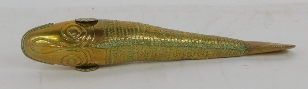 An articulated brass Medina style fish, with cabochon red set eyes ...