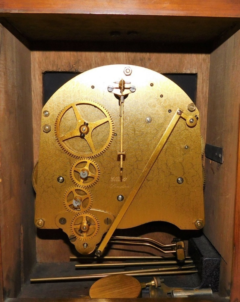 An early 20thC Elliot walnut cased mantel clock, square brass dial with ...