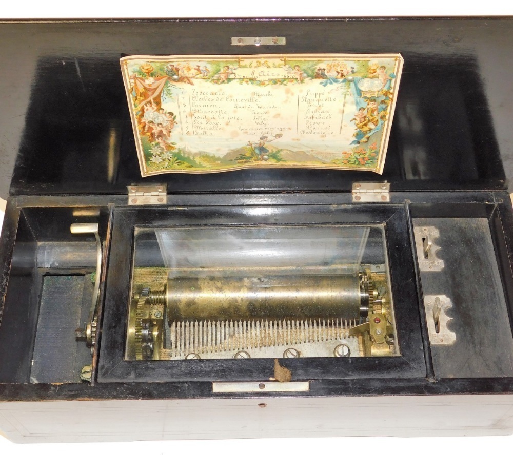 A late 19thC rosewood cased music box, playing eight airs, the hinged ...