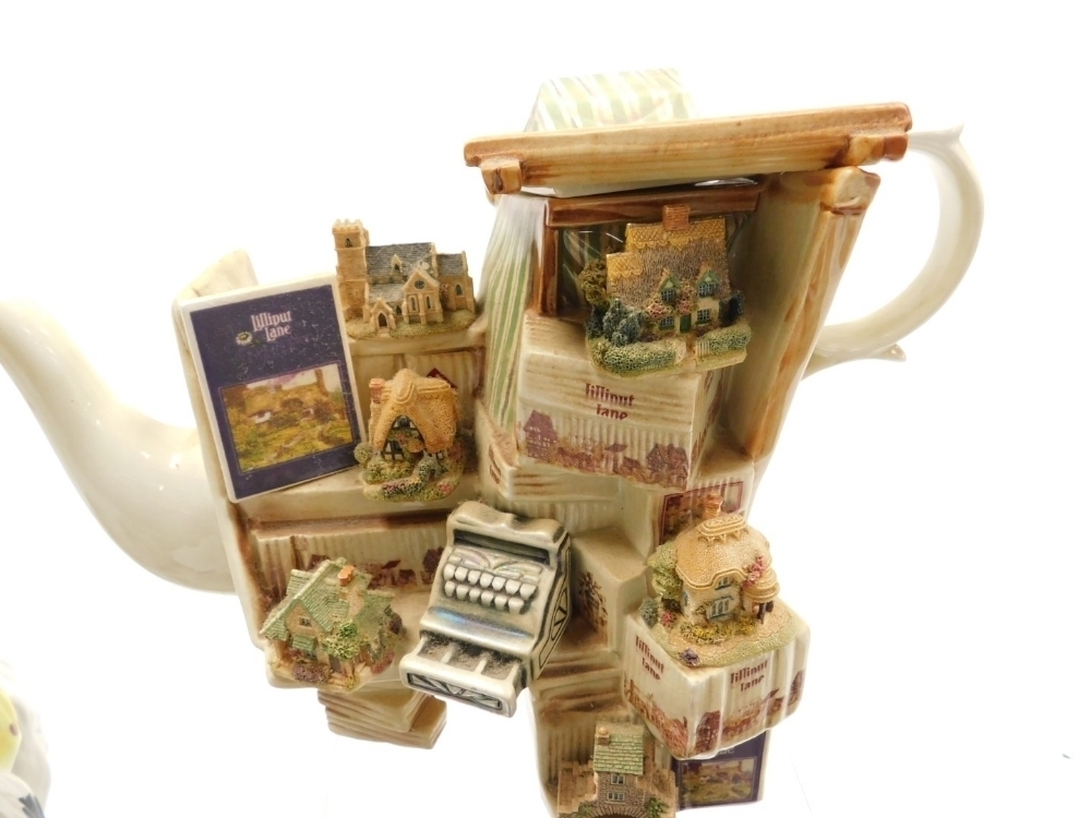 Five novelty pottery teapots, comprising a Saddlers type matt black car ...