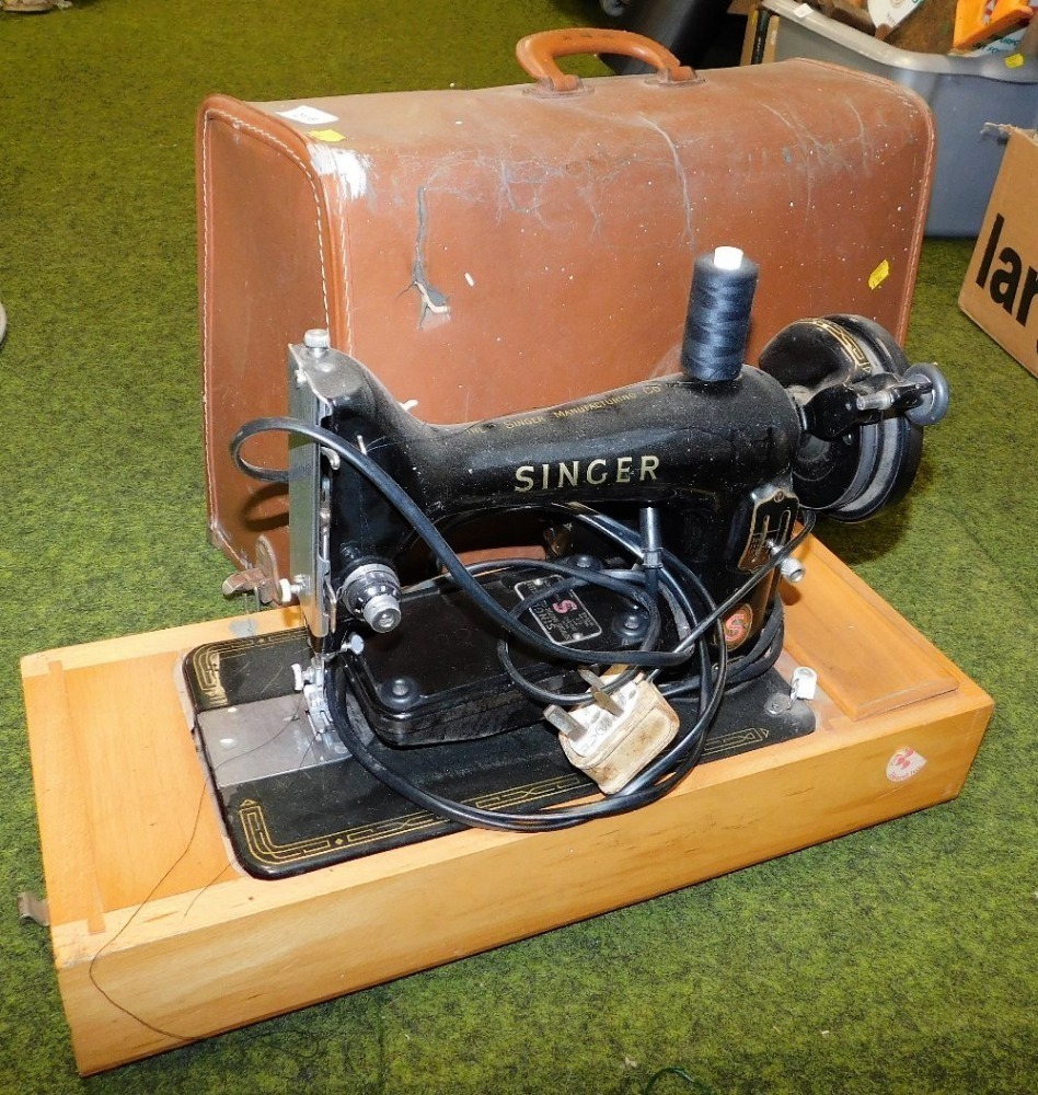 A cased Singer sewing machine. Buyer Note: WARNING! This lot contains ...