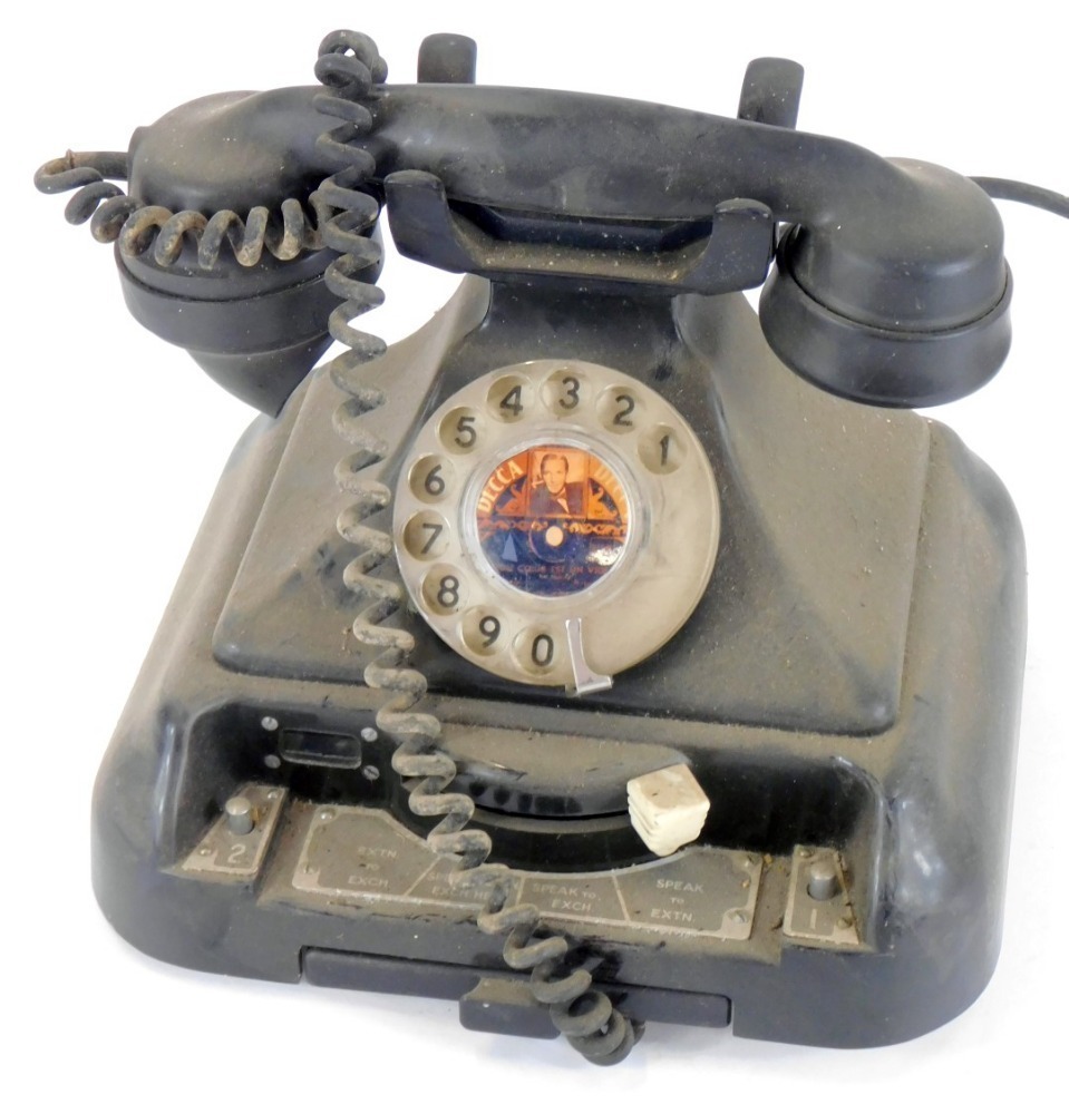 A Decca vintage dial telephone, in black plastic casing, 22cm high.