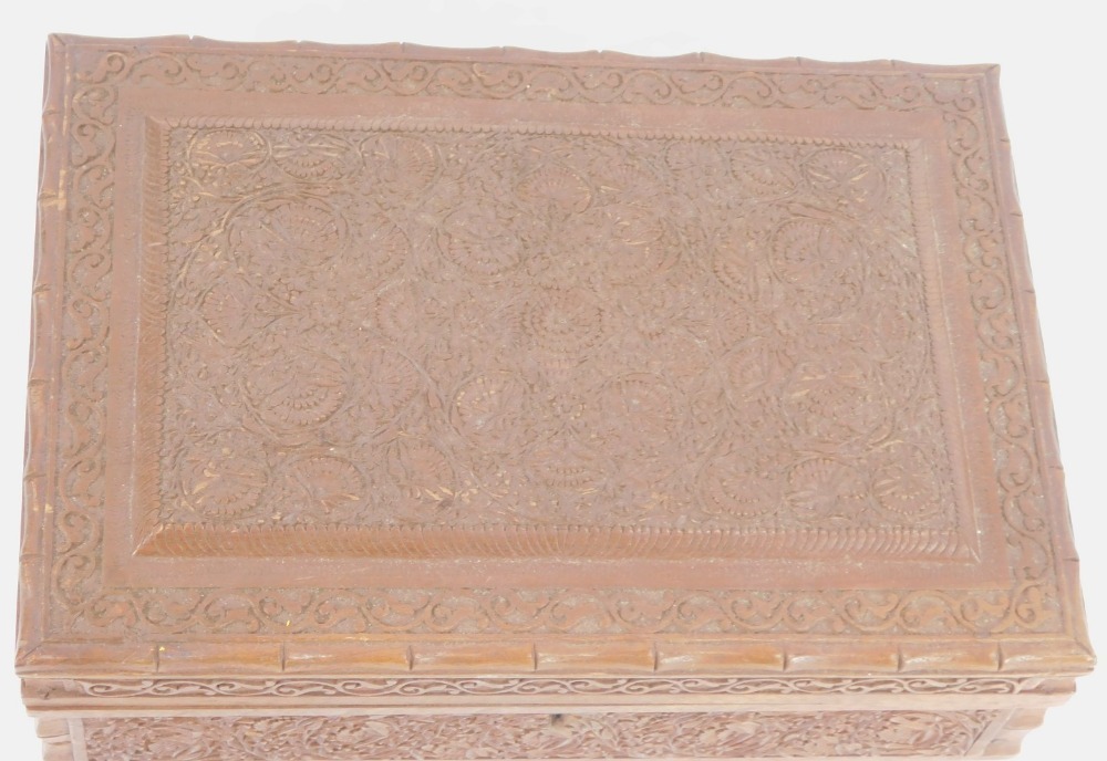 An early 20thC Anglo Indian wooden cigarette box, profusely carved with ...