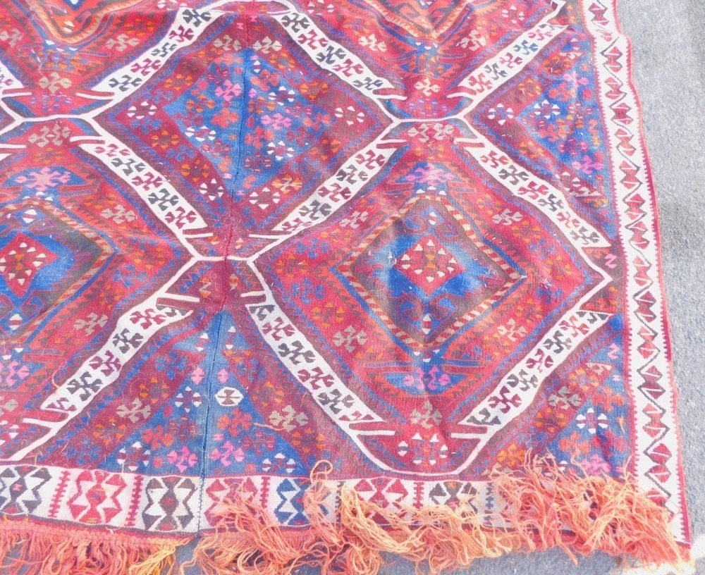 An Eastern inspired rug, formed as two runners with central joining, on ...