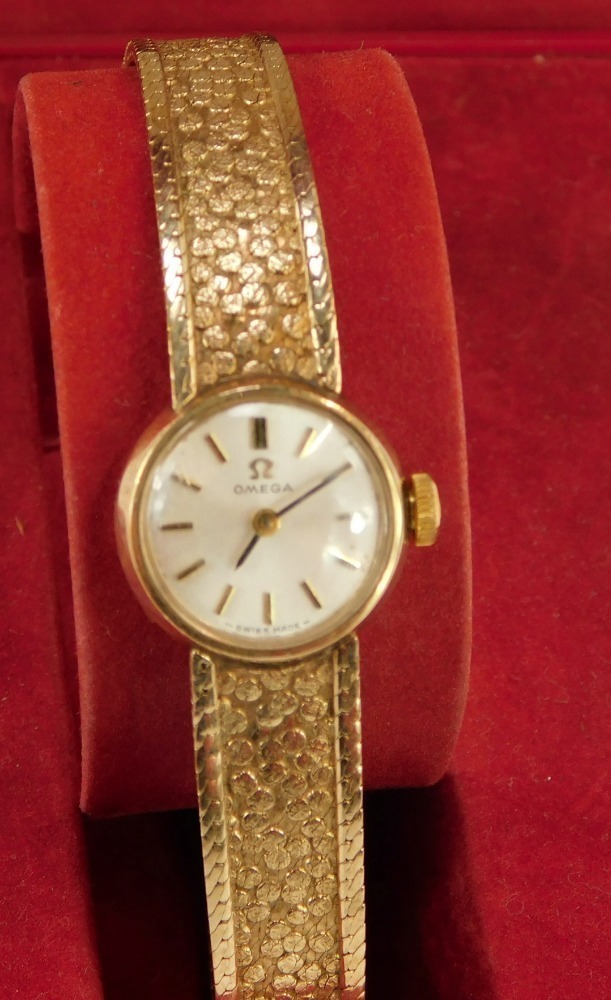 An Omega 9ct gold lady's wristwatch, with small silvered dial, 1.5cm ...