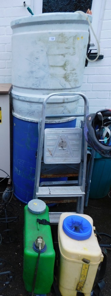 Two large plastic storage tubs, a green bin, two step ladders, and two ...