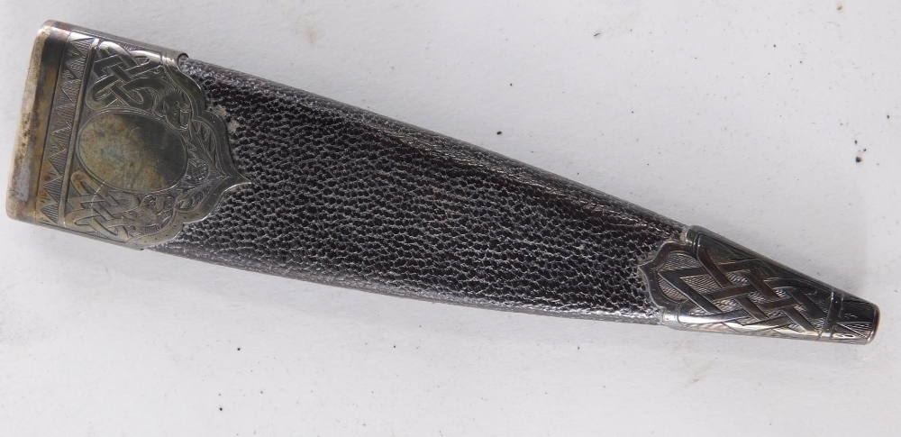 A Scottish dagger, with heavily carved turned handle, compressed pommel ...