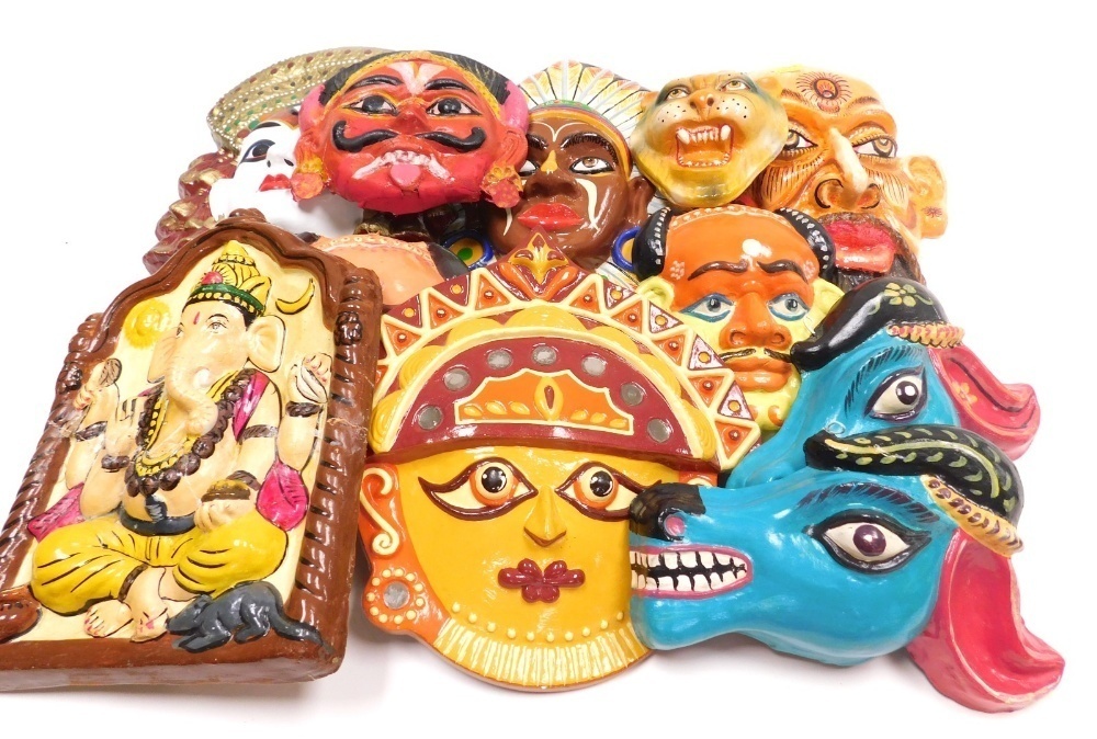A group of Indian papier mache masks, to include various figures ...