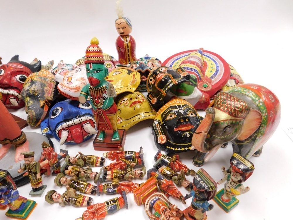 A group of Indian papier mache wall masks, to include depictions of ...