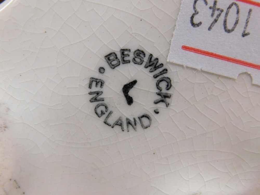 A group of Beswick pottery figures modelled as cats, in various poses ...