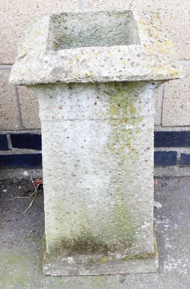A concrete chimney stack, of square tapering form with outswept lip ...