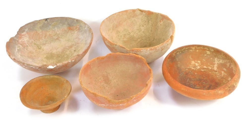 A collection of early Grecian earthenware pottery dishes, including ...