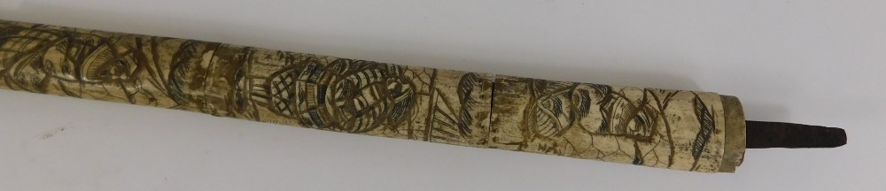 A Japanese bone cased kutana sword, the scabbard carved with figures ...