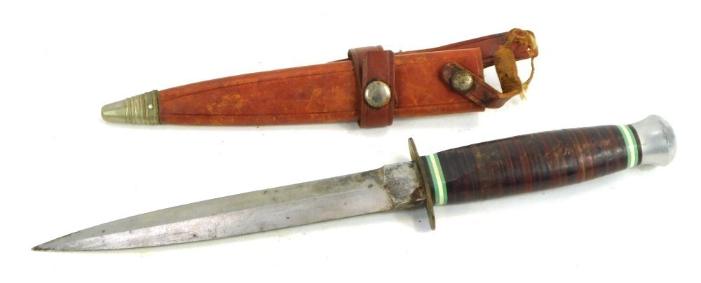 A Middle Eastern dagger, with a turned wooden handle and leather ...