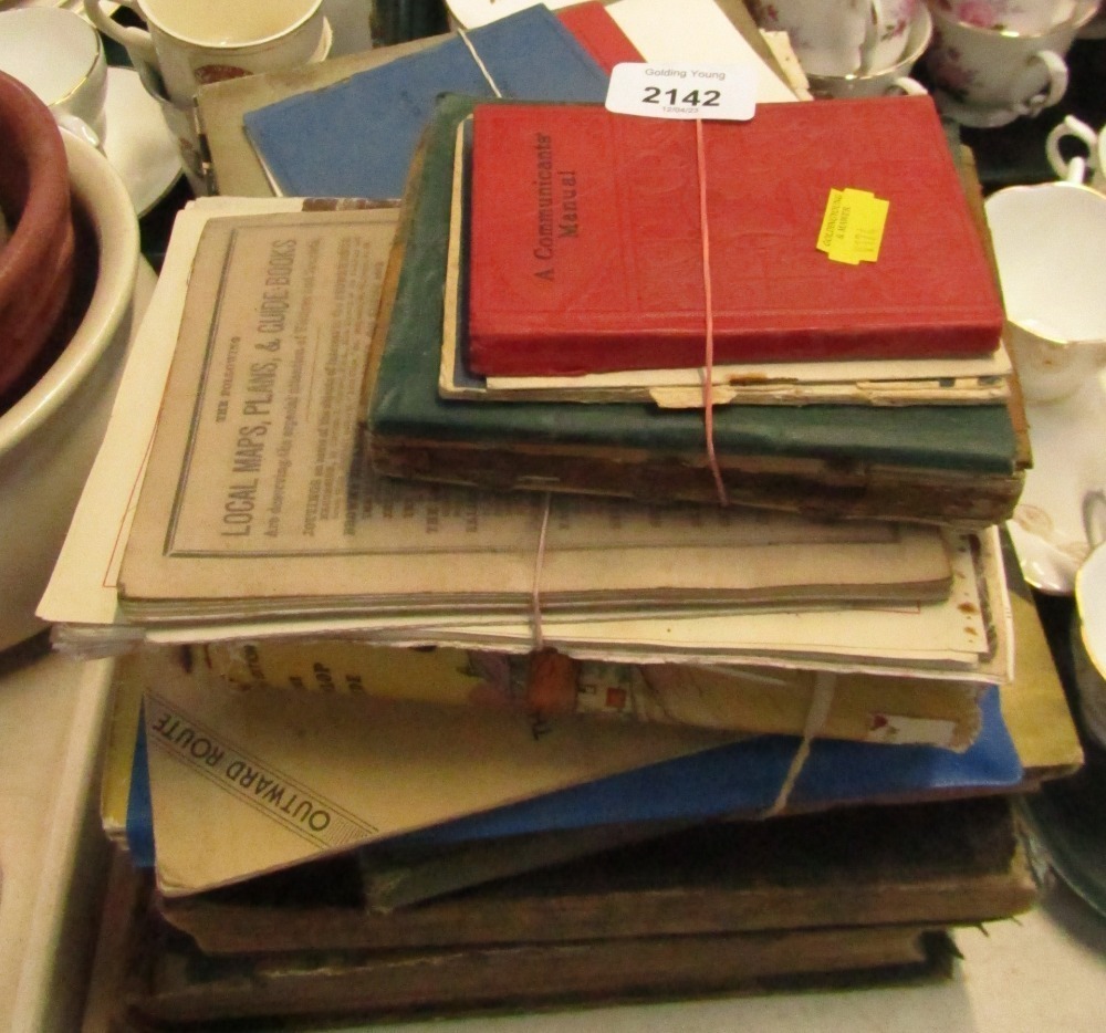 A collection of books, communal manuals, paper maps and guides, tour ...