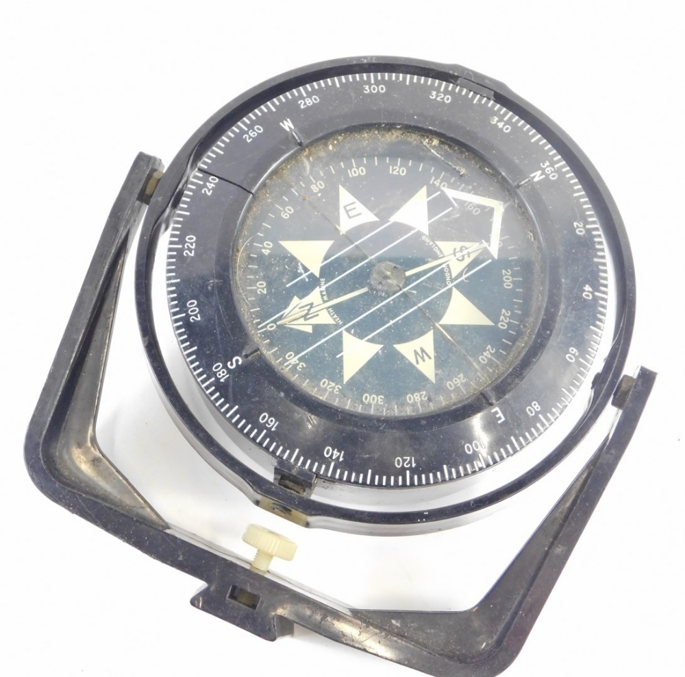 A metal cased ship's compass, with white stencilled Arabic dial, in ...