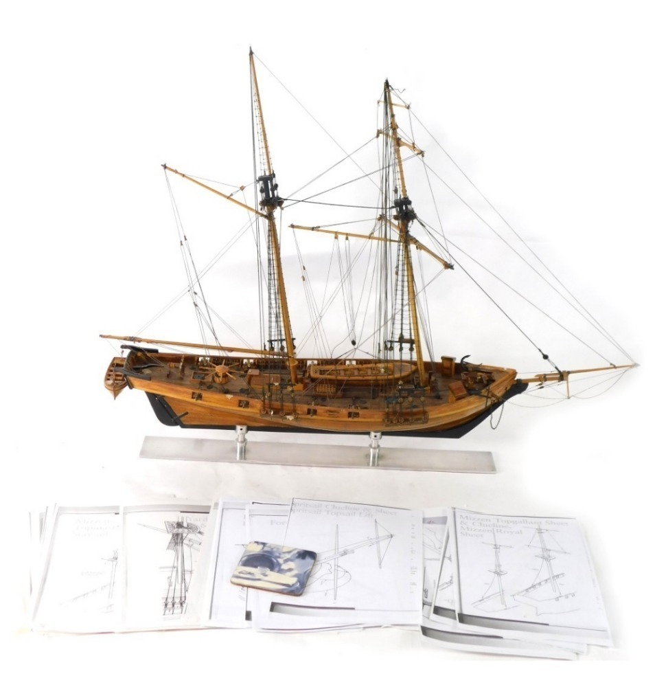 A scale model of a ship, with realistic rigging and deck, on stand ...