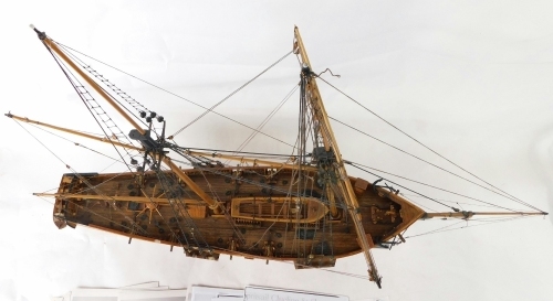 A scale model of a ship, with realistic rigging and deck, on stand ...