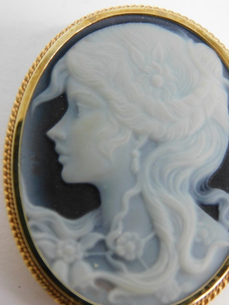 A blue agate cameo, side quarter profile, in a 9ct gold mount with rope ...