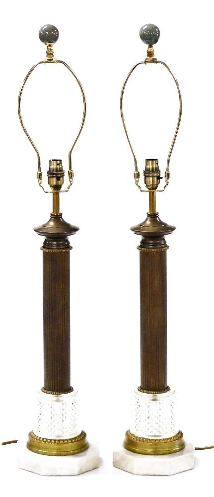 A pair of brass and moulded glass column lamp bases, with octagonal ...
