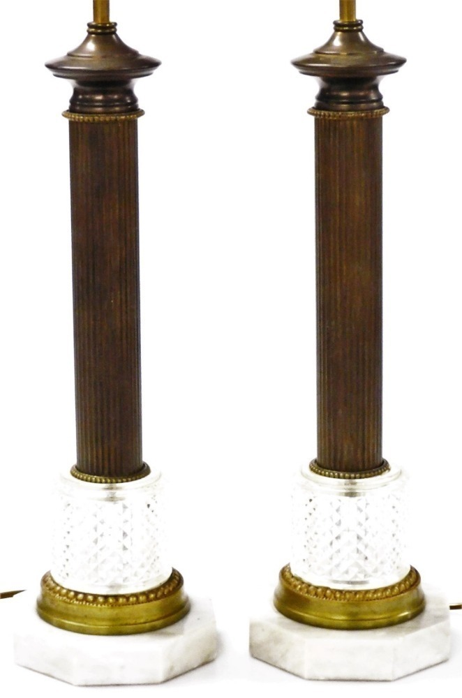 A pair of brass and moulded glass column lamp bases, with octagonal ...