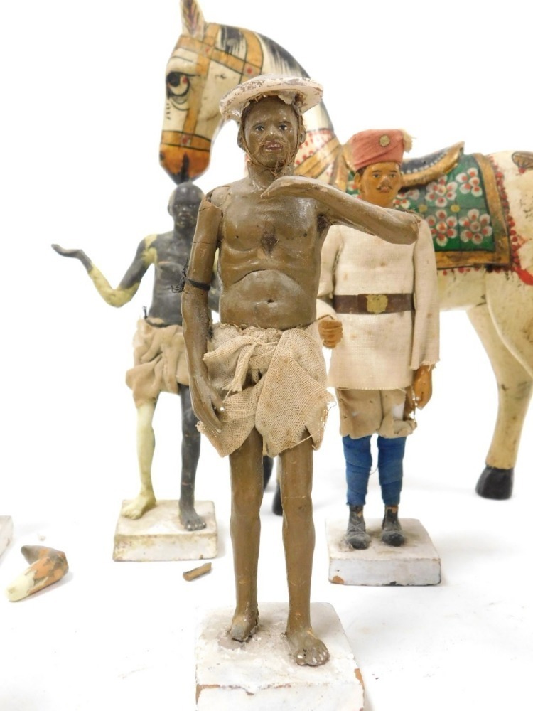 Three early 20thC Indian painted wooden carvings of horses, further ...