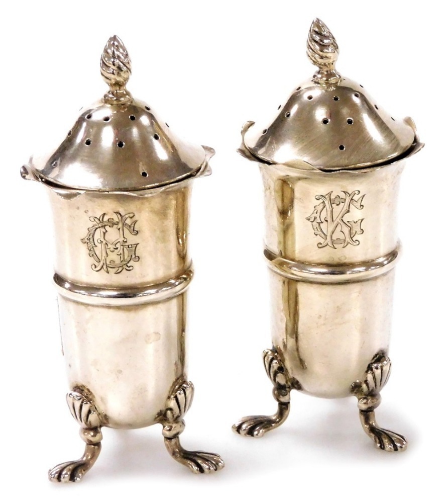 A pair of late Victorian silver pepperettes, each with a flame finial ...