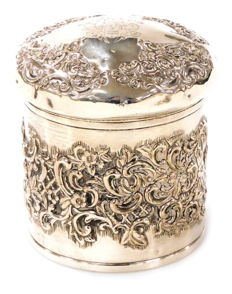 A Victorian silver dressing table box, of cylindrical form embossed ...