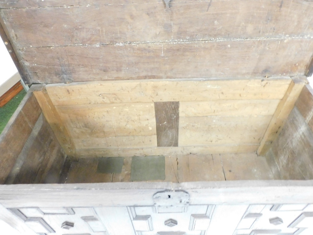 A 17thC oak coffer, with a cast iron lock plate and triple panelled ...