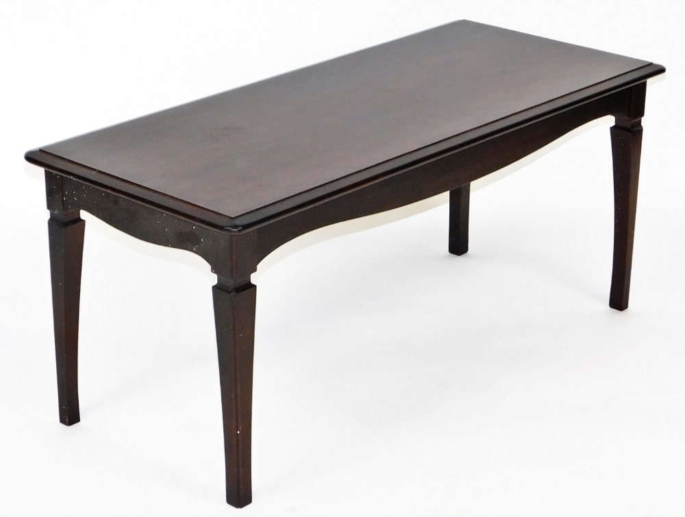 A Stag mahogany coffee table, with a rectangular top, raised on ...