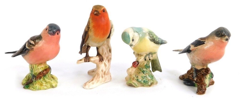 A group of four pottery birds, Beswick Blue Tit, two Chaffinches, and a ...