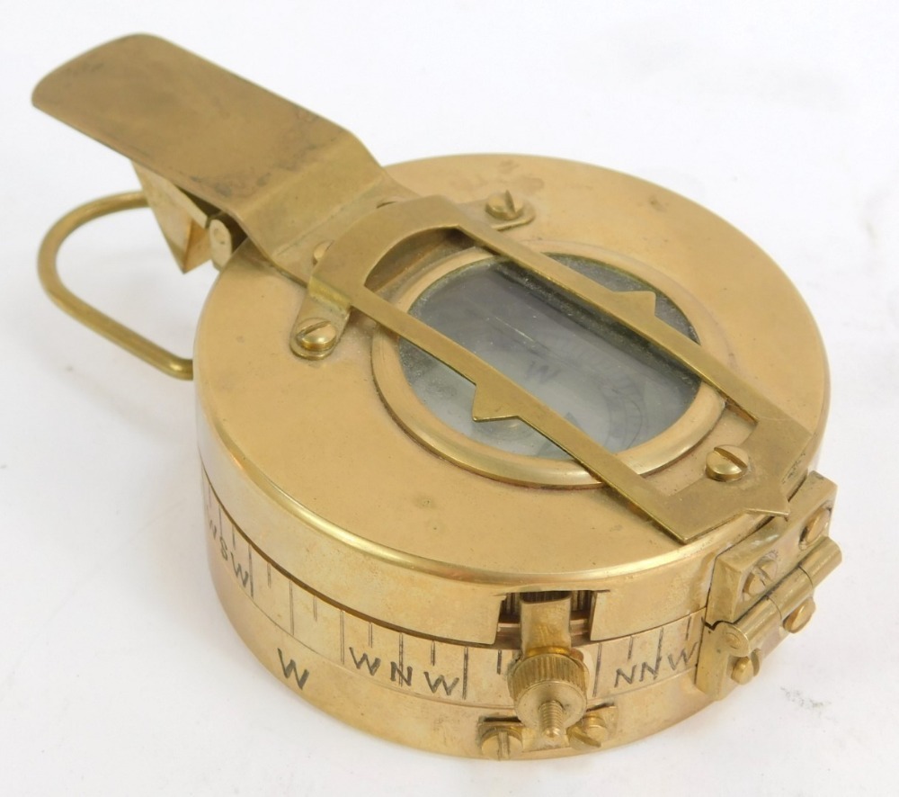 A replica WWII brass compass, stamped to underside T G Co Ltd, London ...