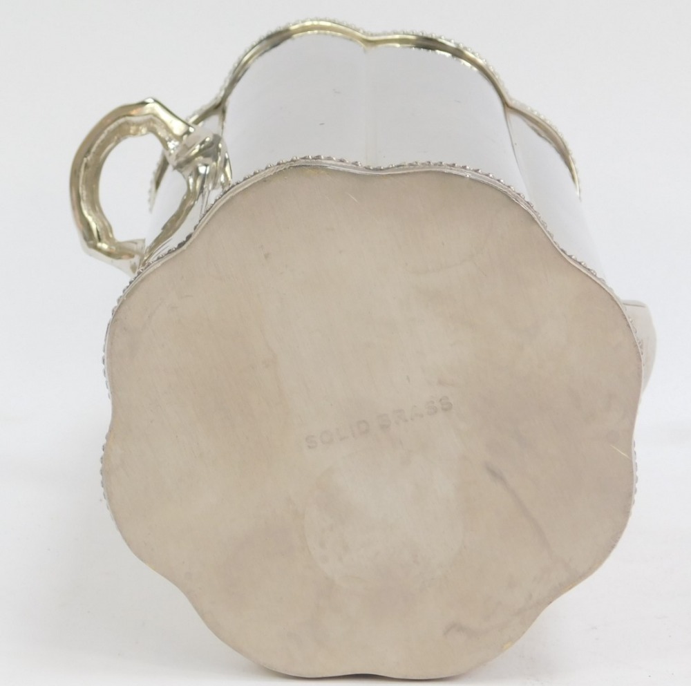 A silver plated twin handled wine bottle holder, of fluted form, with a ...