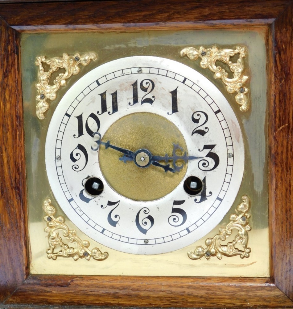A late 19thC German oak cased mantel clock, the brass square dial with ...