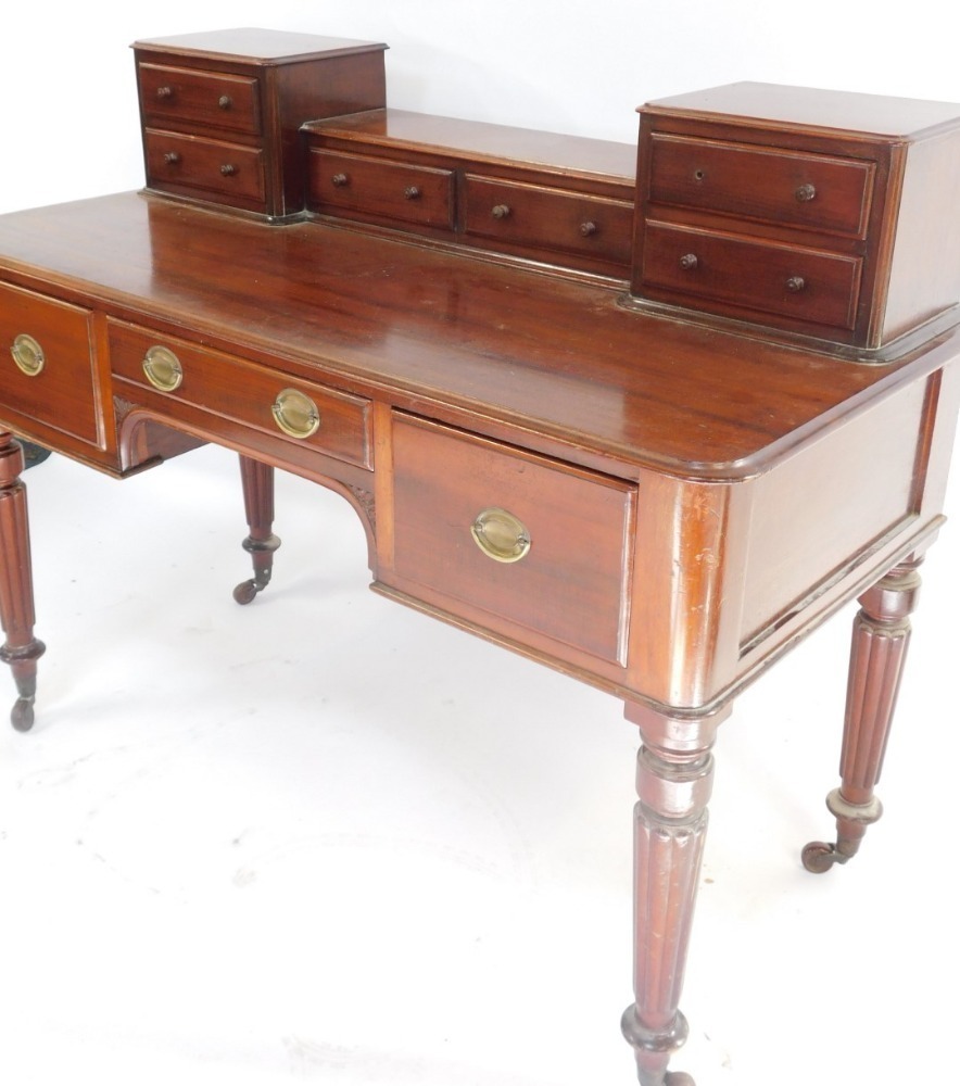 An early Victorian mahogany writing table, the raised back with an ...