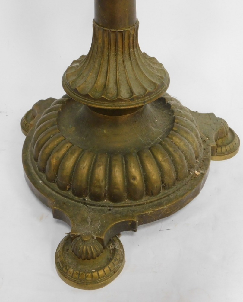 A Victorian brass standard lamp, with a fluted column, raised on a ...