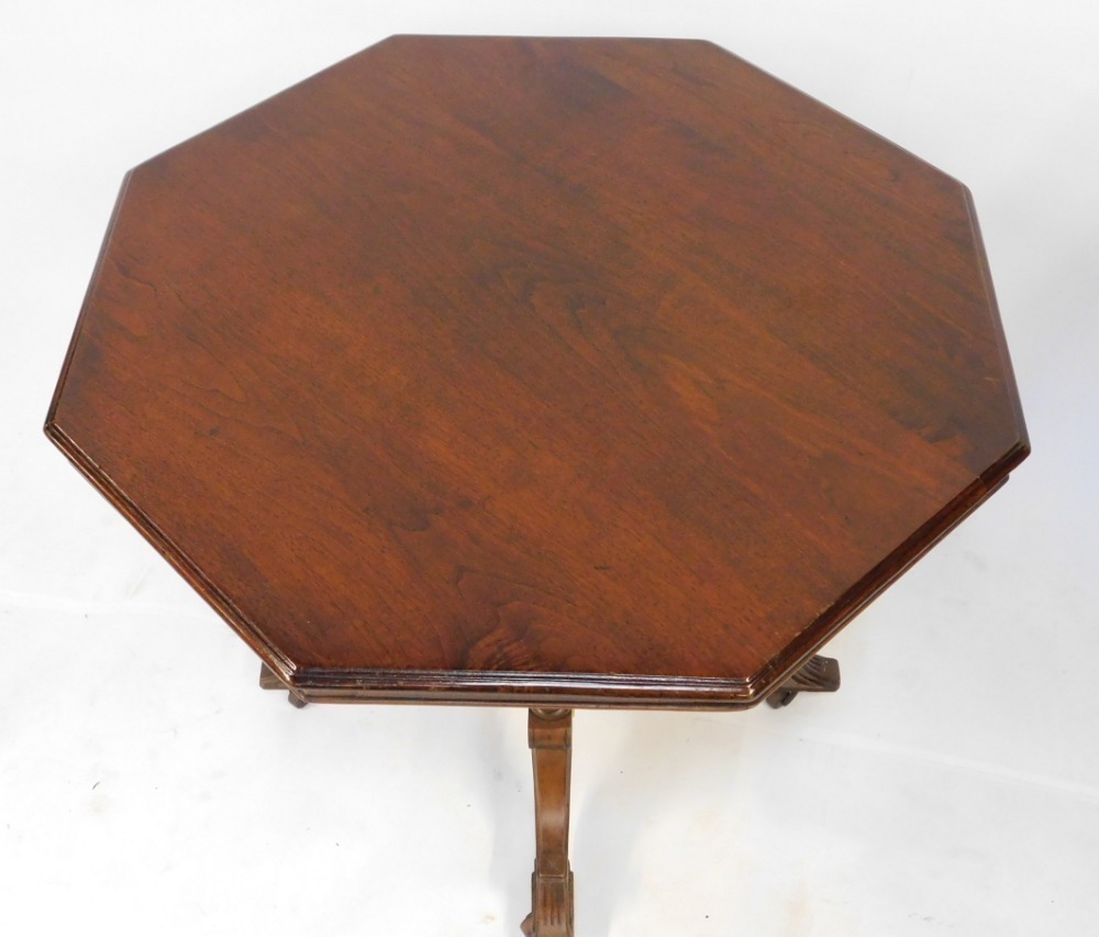A Victorian mahogany octagonal window table, raised on turned supports ...