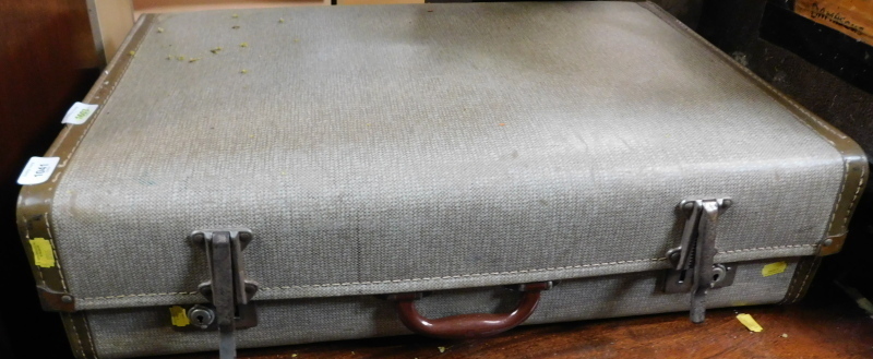 A vintage material bound Cheney suitcase.