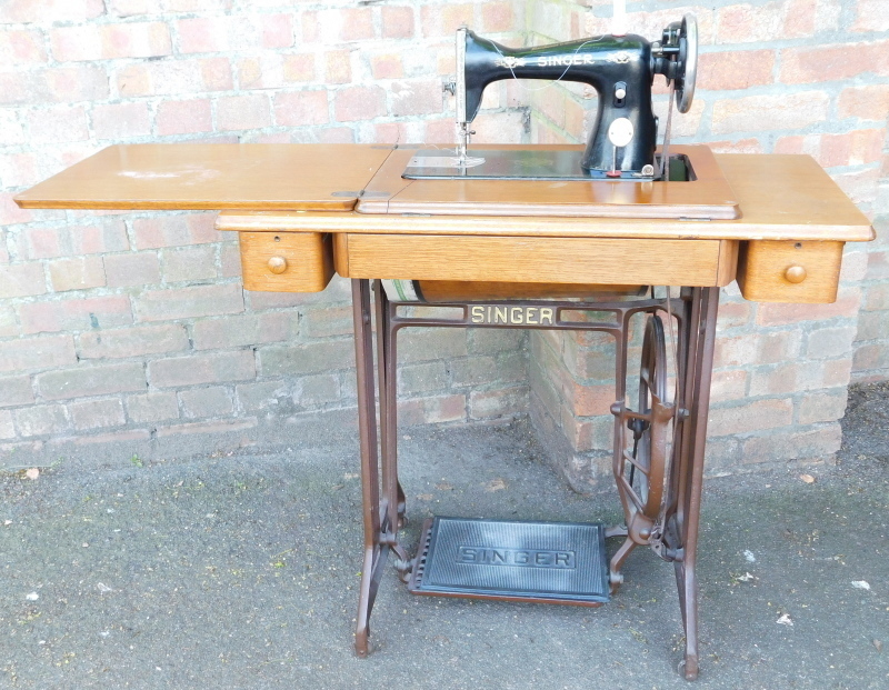 An oak and cast iron Singer sewing machine table with vintage sewing ...