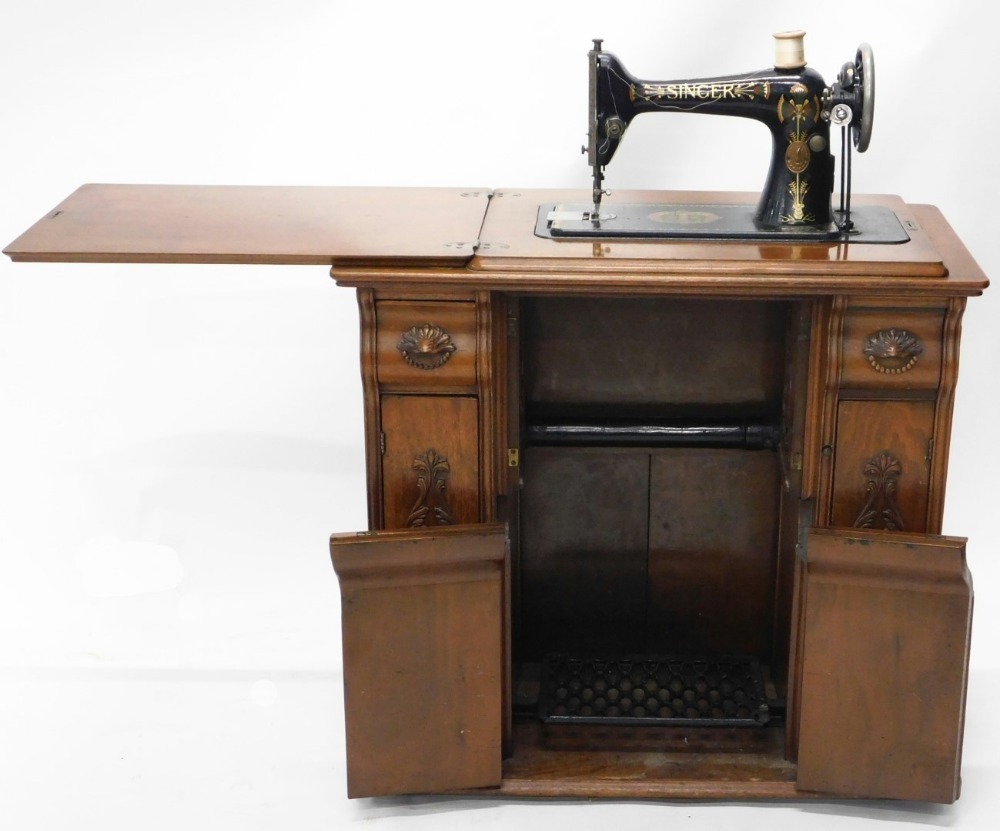An unusual Singer treadle freestanding cased sewing machine, in a ...