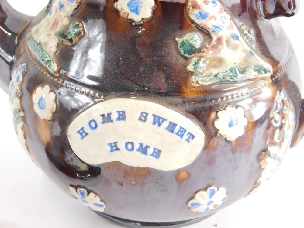 A Bargeware treacle glazed pottery teapot, with teapot knop, raised ...